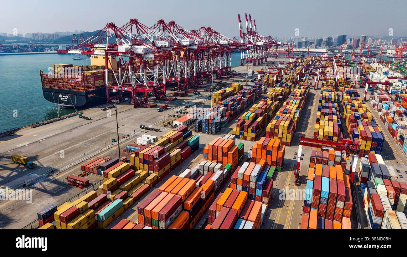 Workers handle cargo at Qingdao Port in east China's Shandong Province ...