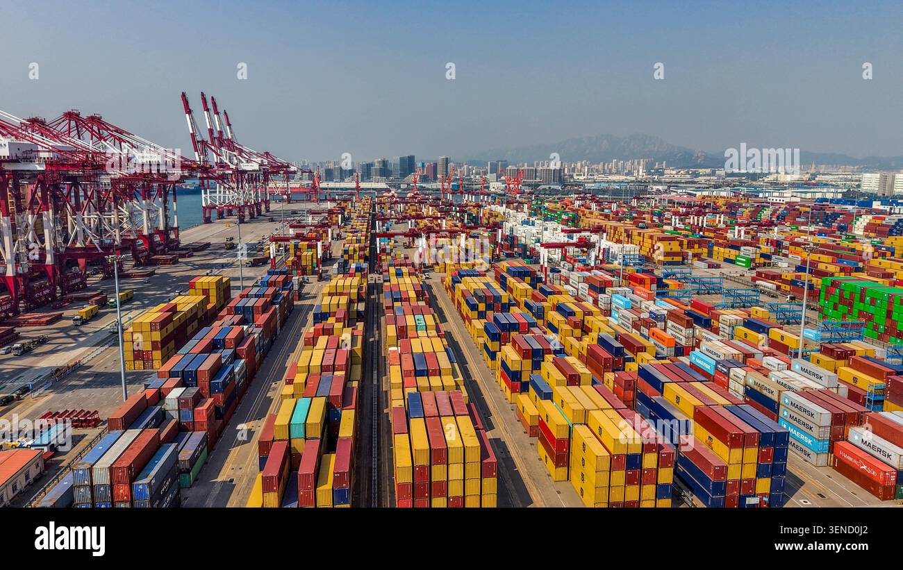 Workers handle cargo at Qingdao Port in east China's Shandong Province ...