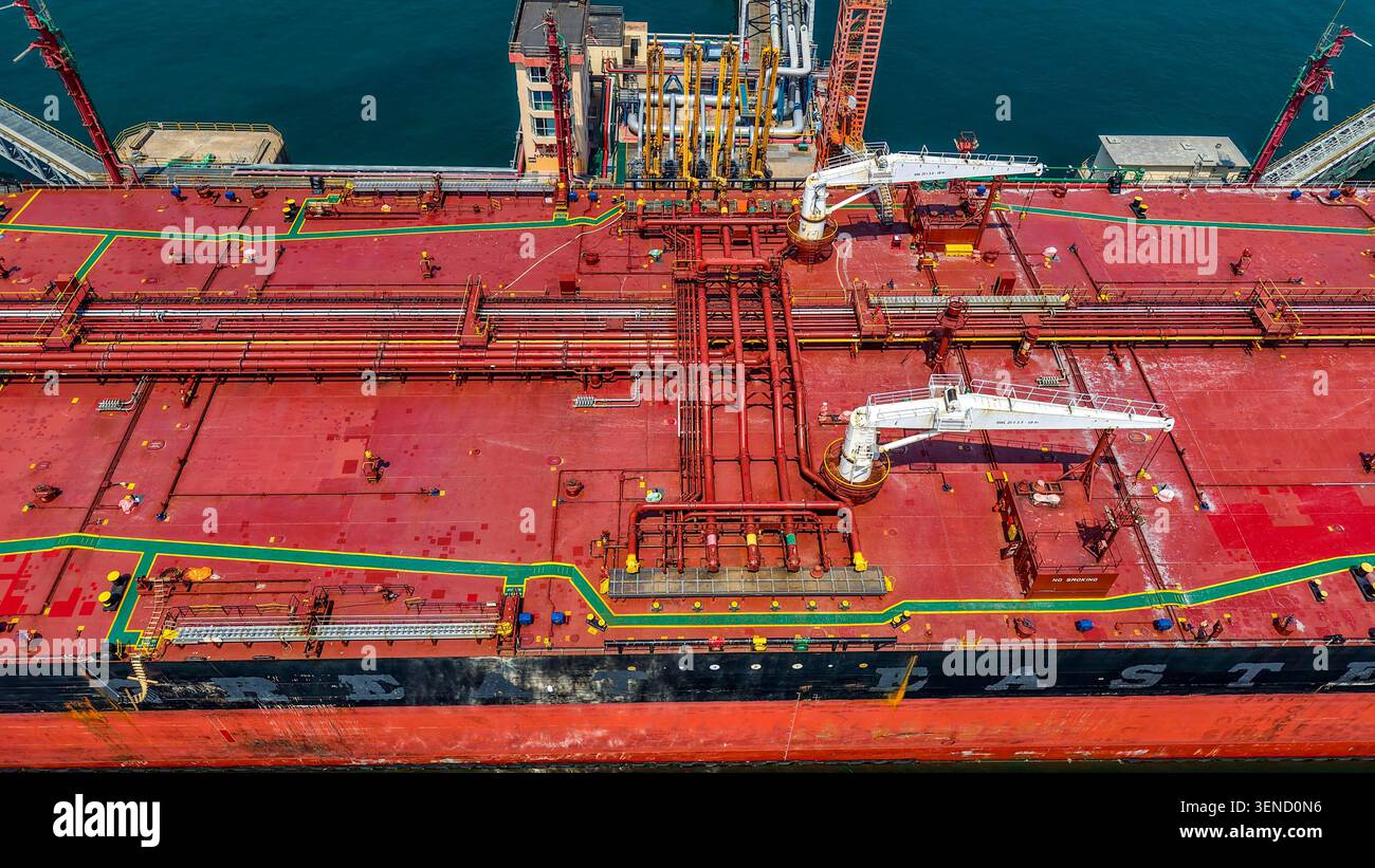 An oil tanker unloads imported crude oil at the oil port terminal of ...