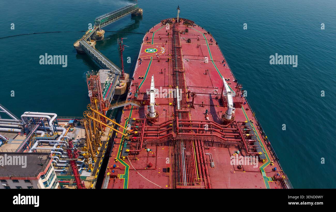 An oil tanker unloads imported crude oil at the oil port terminal of ...