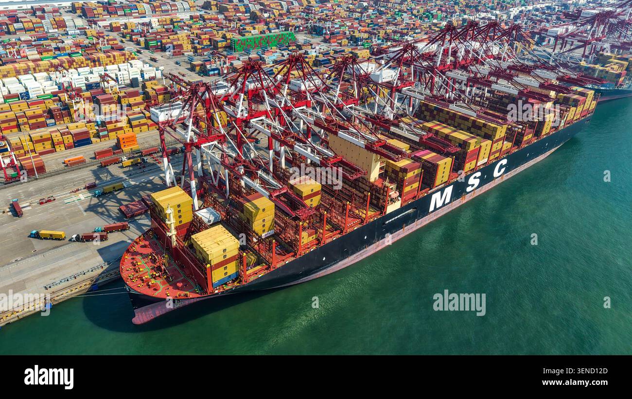 Workers handle cargo at Qingdao Port in east China's Shandong Province ...