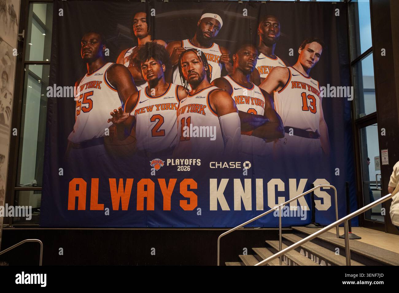 A New York Knicks banner displays multiple players in orange and white ...