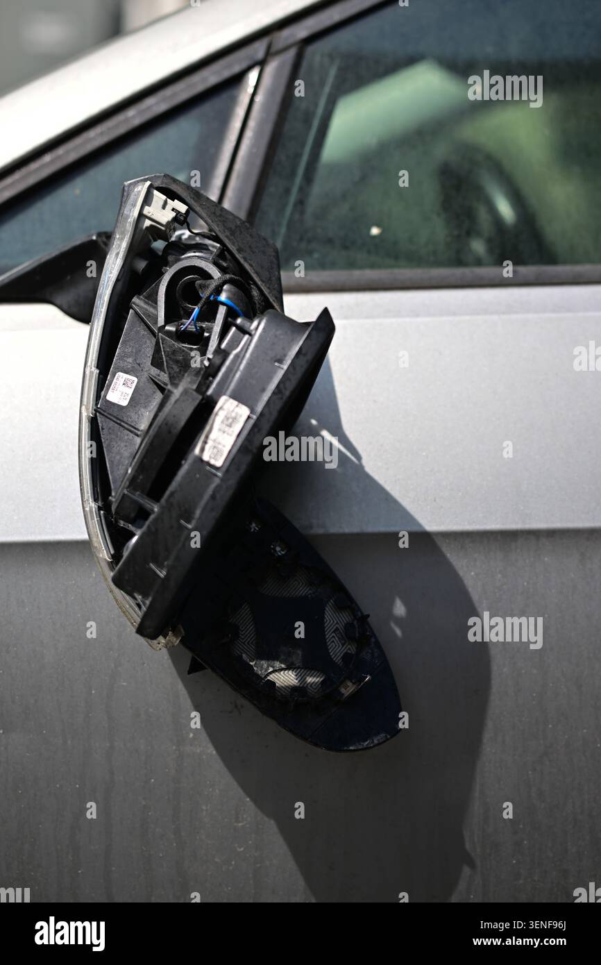 08 June 2026, Berlin: A worn wing mirror is hanging on a car. Photo ...
