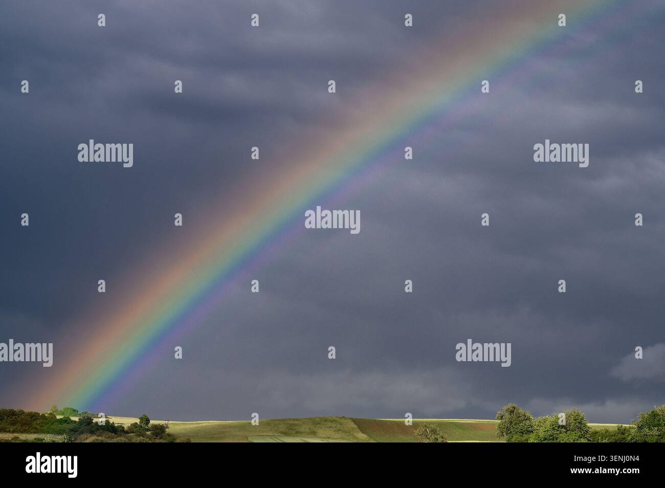 11 June 2026, Hesse, Germerode: A rainbow spans the landscape in ...