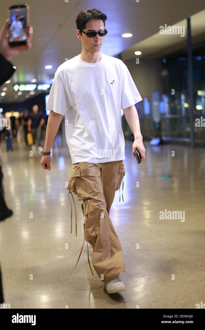 Chinese singer Ayanga wears white T-shirt with cargo pants at Shanghai ...