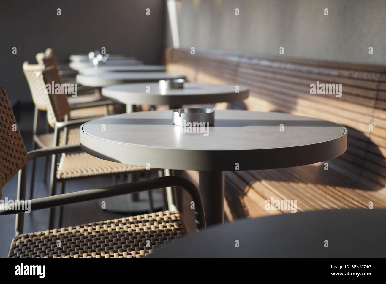 Tables and chairs in a quiet cafe during the day Stock Photo - Alamy