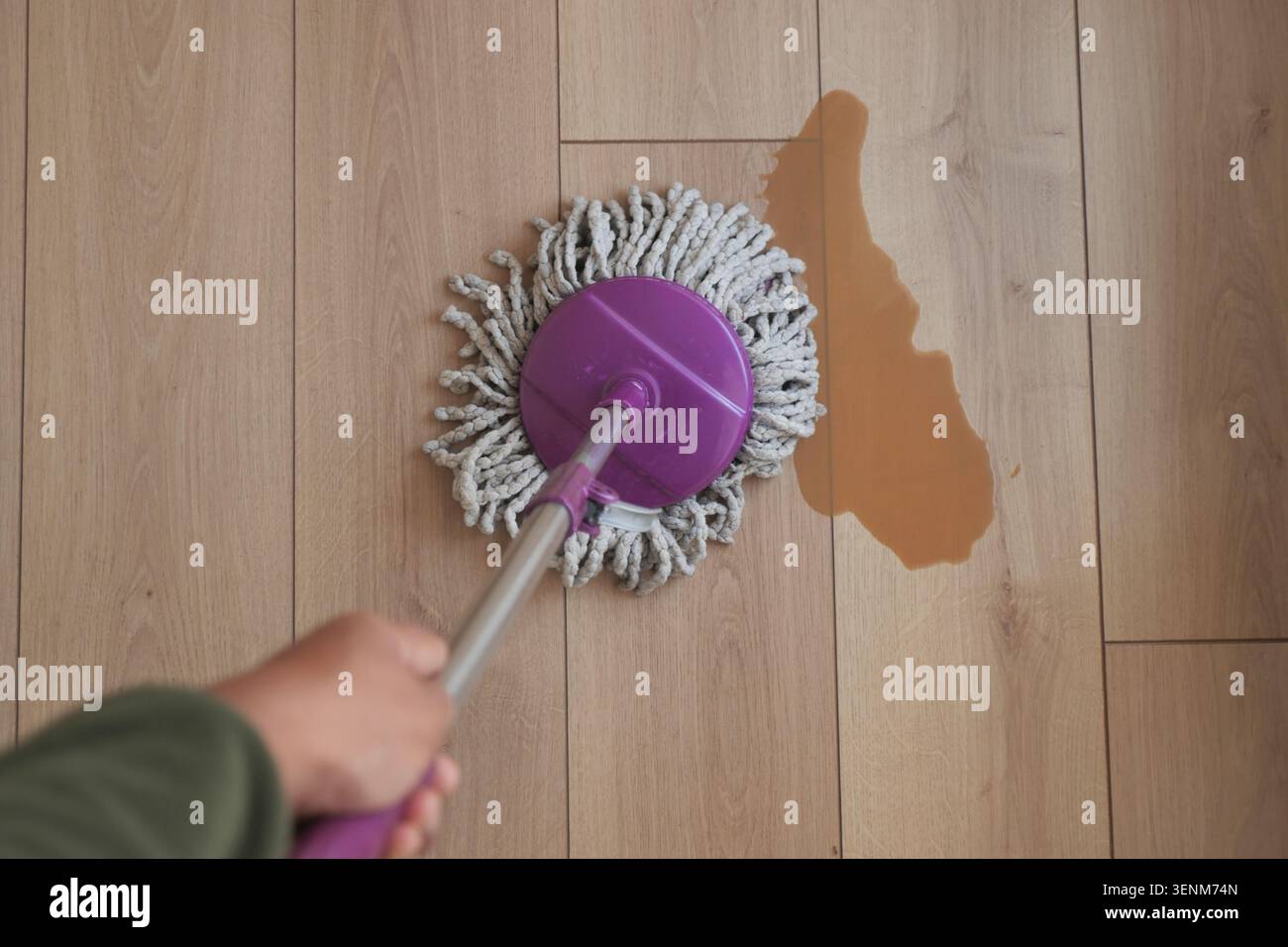 Cleaning a floor with a mop and spilled liquid Stock Photo - Alamy