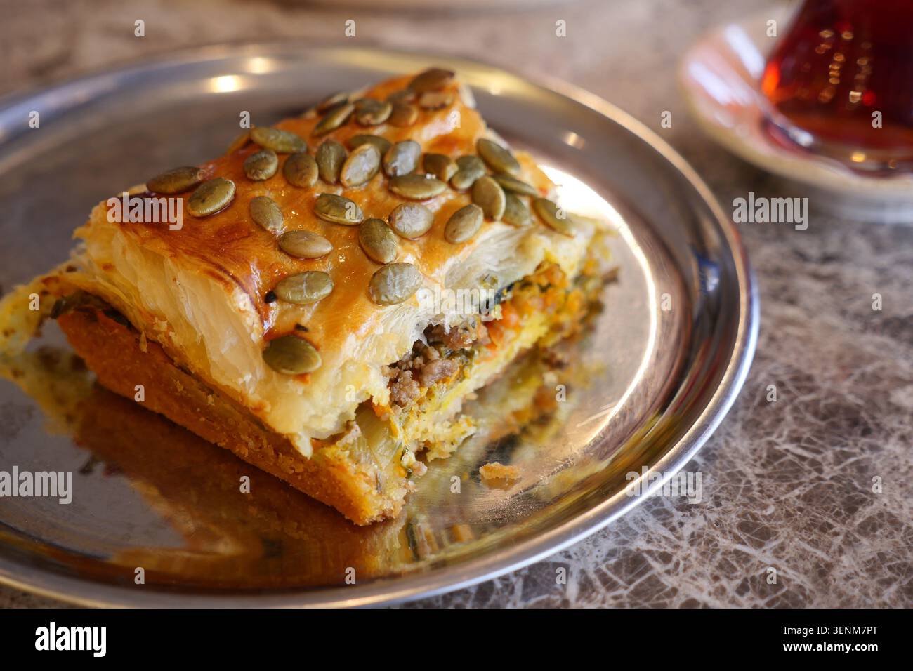 Freshly baked savory pastry with seeds on a plate Stock Photo - Alamy