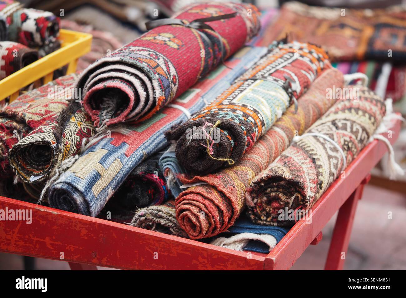 Colorful rolled rugs on display at a market stall Stock Photo - Alamy