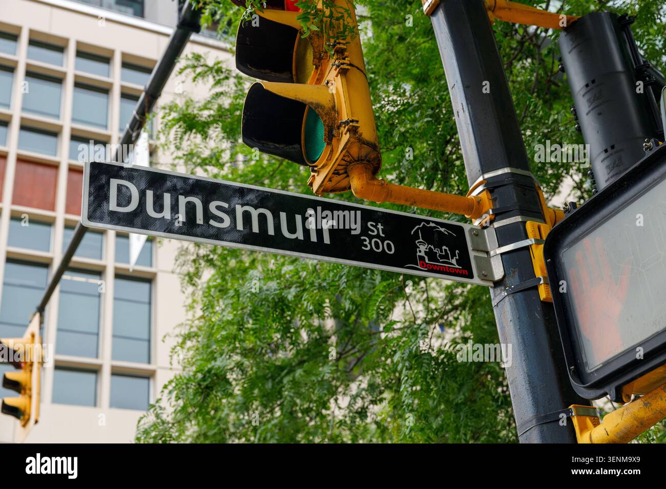 A black Dunsmuir St 300 block placard with the Downtown BIA skyline ...