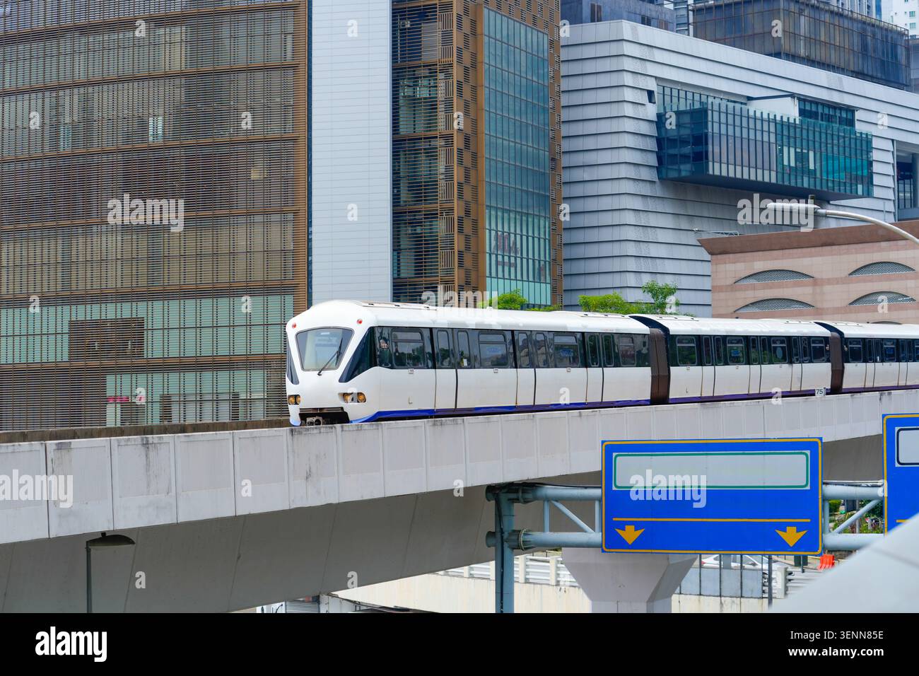High-speed, driverless metro train travels across a city skyline on a ...