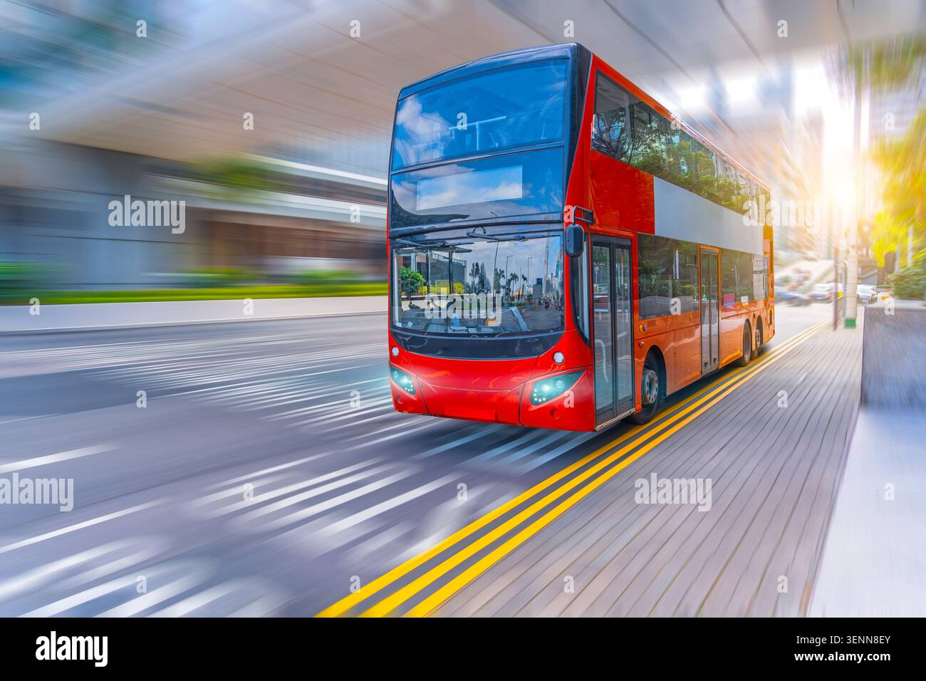 Colorful red double-decker bus moves quickly through motion blur effect ...