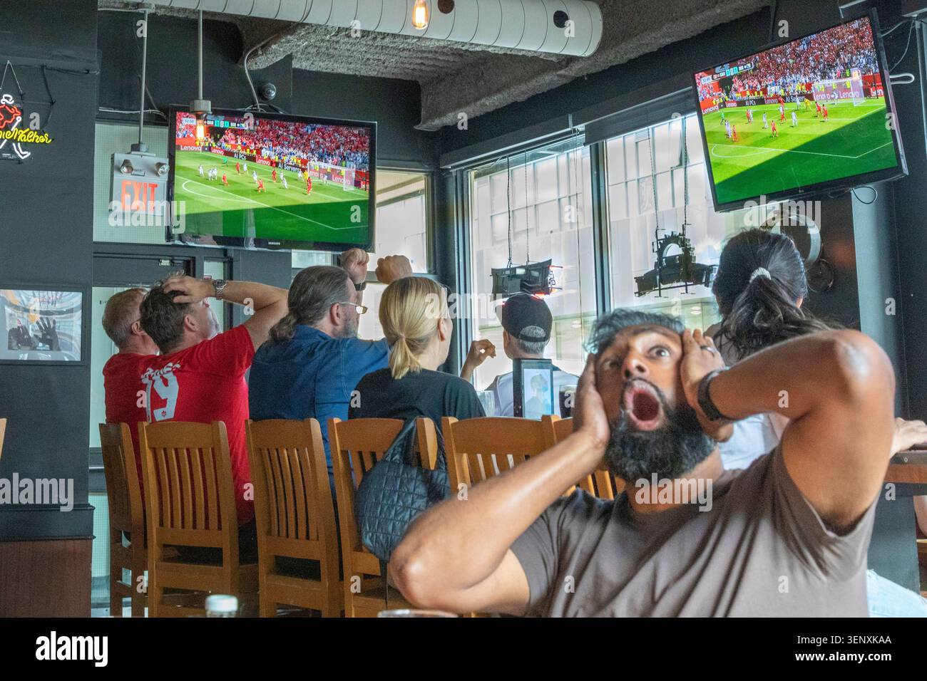 Toronto, Canada, 12th Jun 2026. World Cup soccer fans in a pub react as ...
