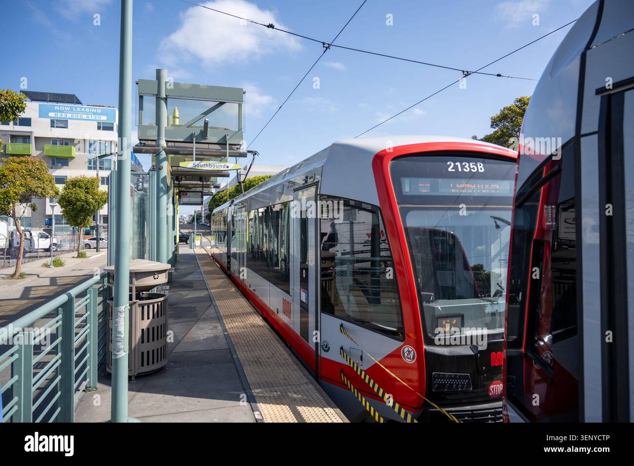 MUNI train in a streetside station on sunny day, San Francisco ...