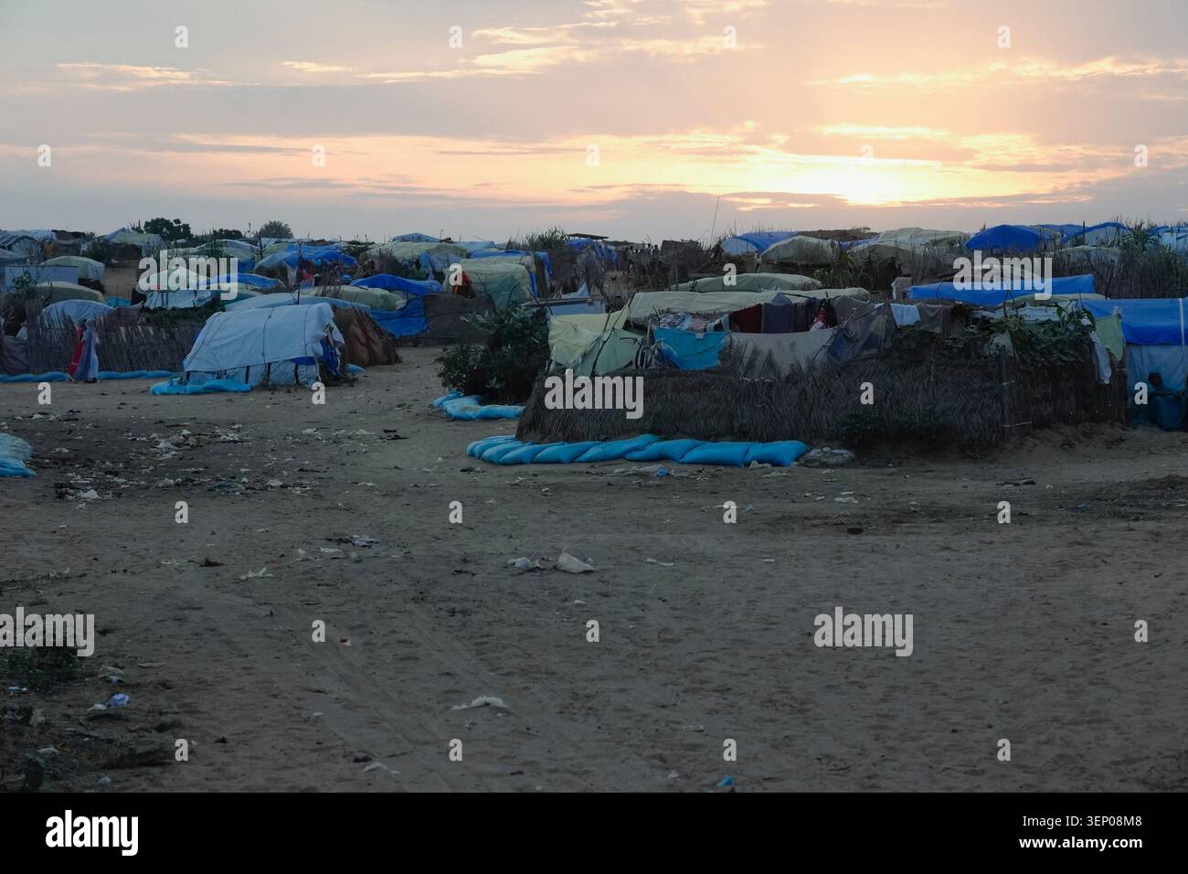 FILE - The sun sets on a refugee camp set up people fleeing war in ...