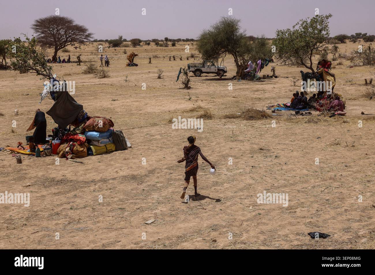 FILE - Refugees run for food in the Tine transit camp in Chad's Wadi ...