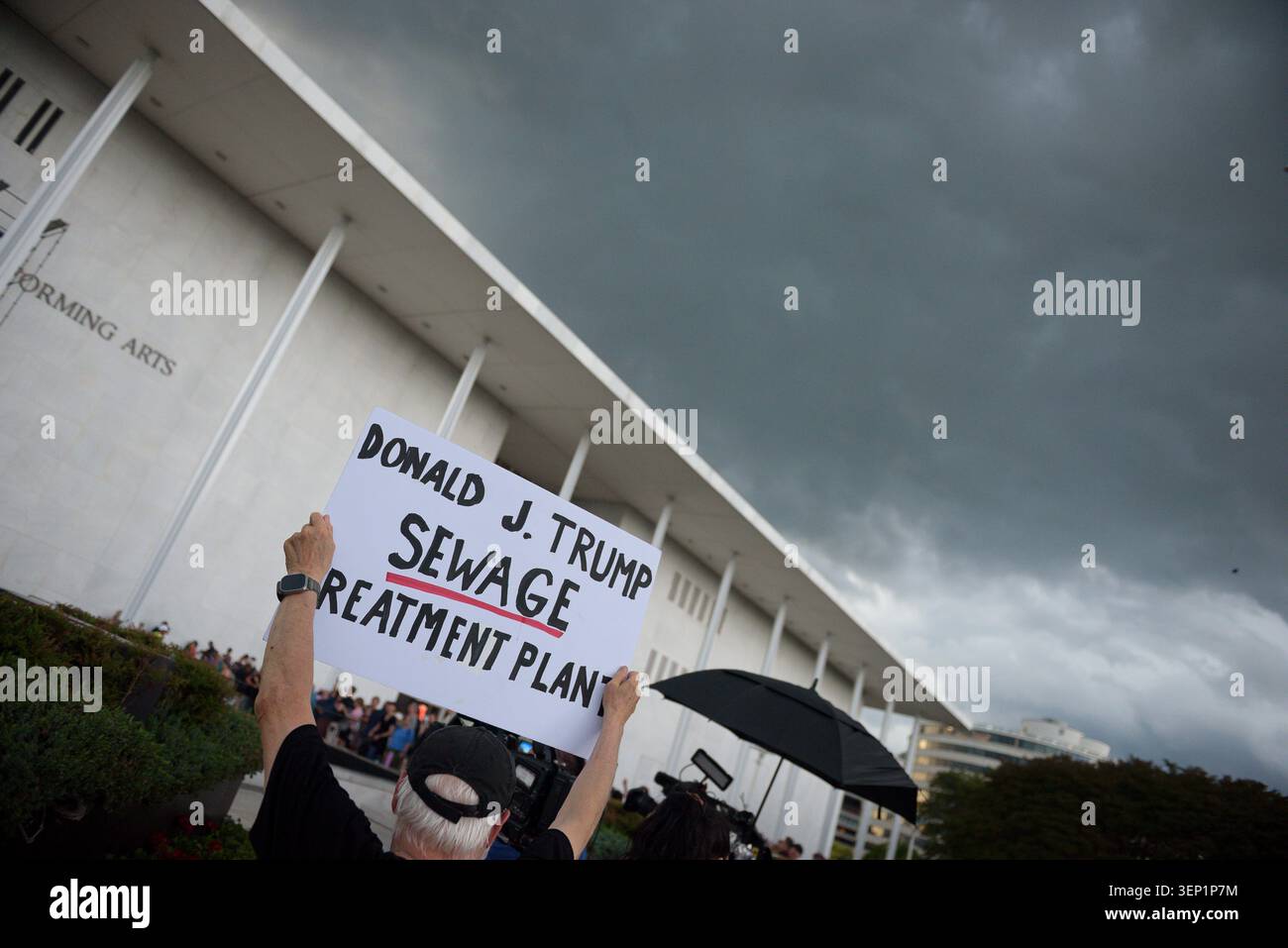 A protester hoists his sign outside the John F. Kennedy Center for the ...