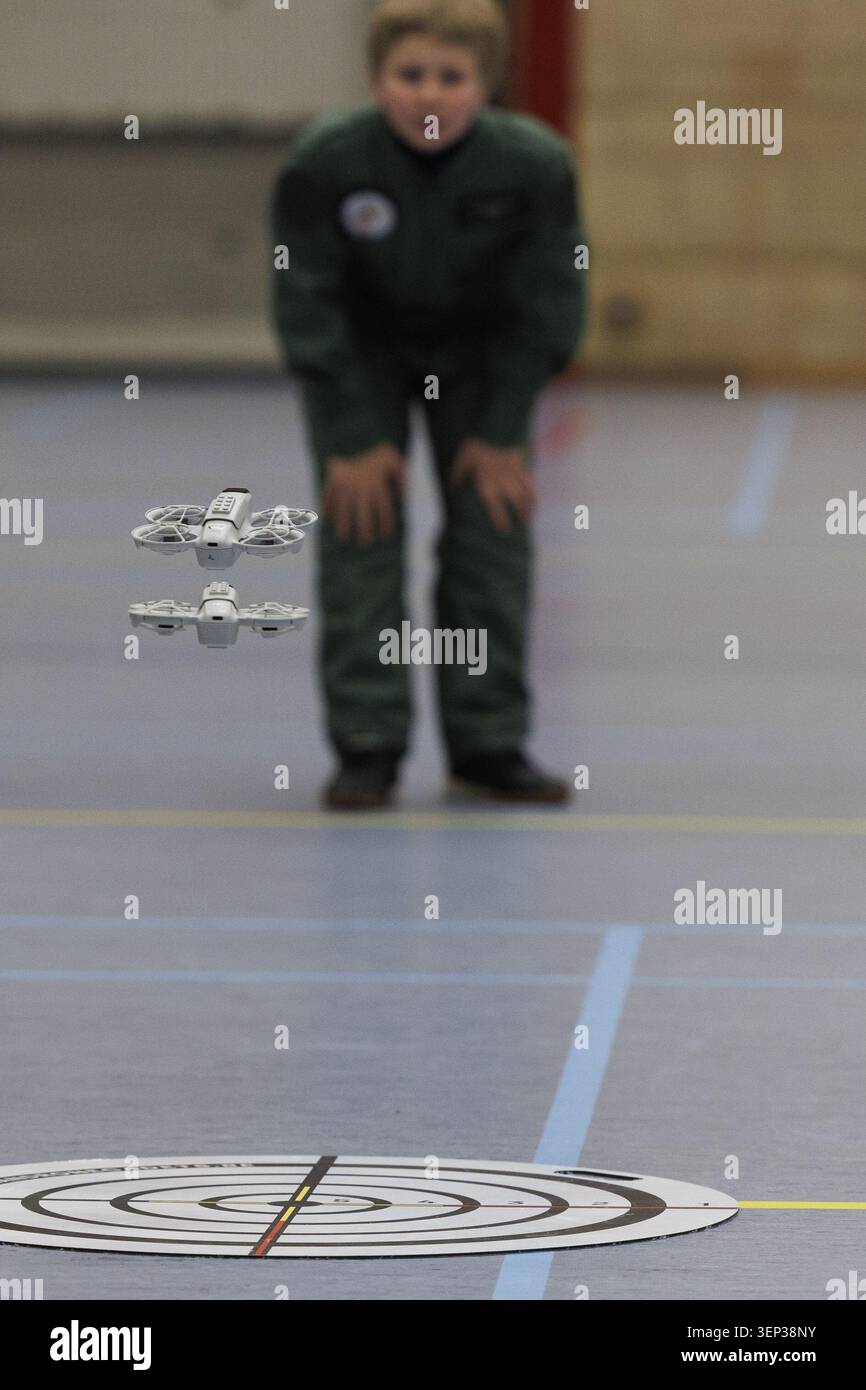 Kids learn to operate a drone whilst playing pictured during a 'drone ...