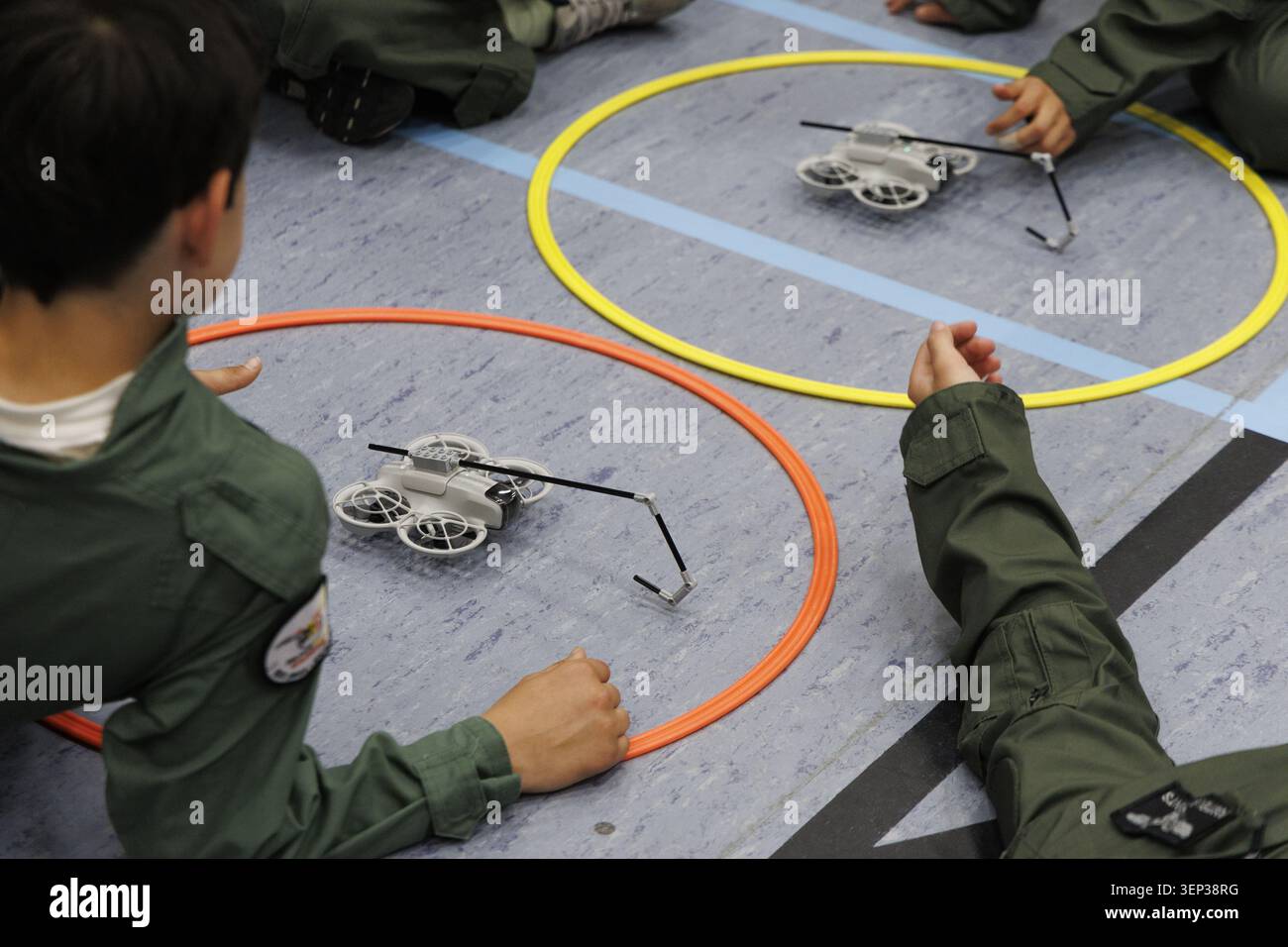 Kids learn to operate a drone whilst playing pictured during a 'drone ...