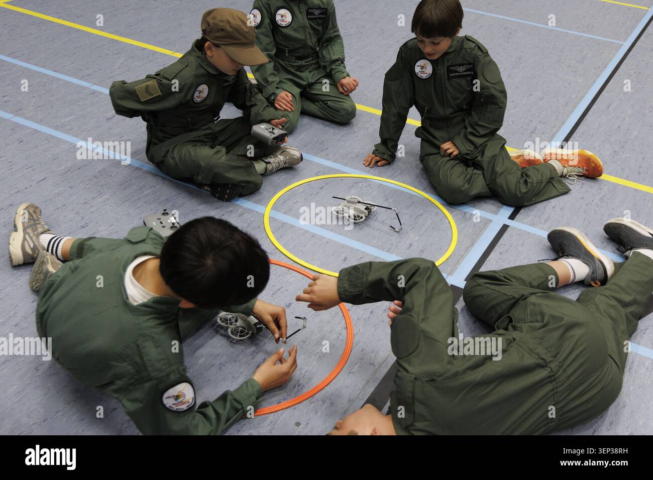 Kids learn to operate a drone whilst playing pictured during a 'drone ...