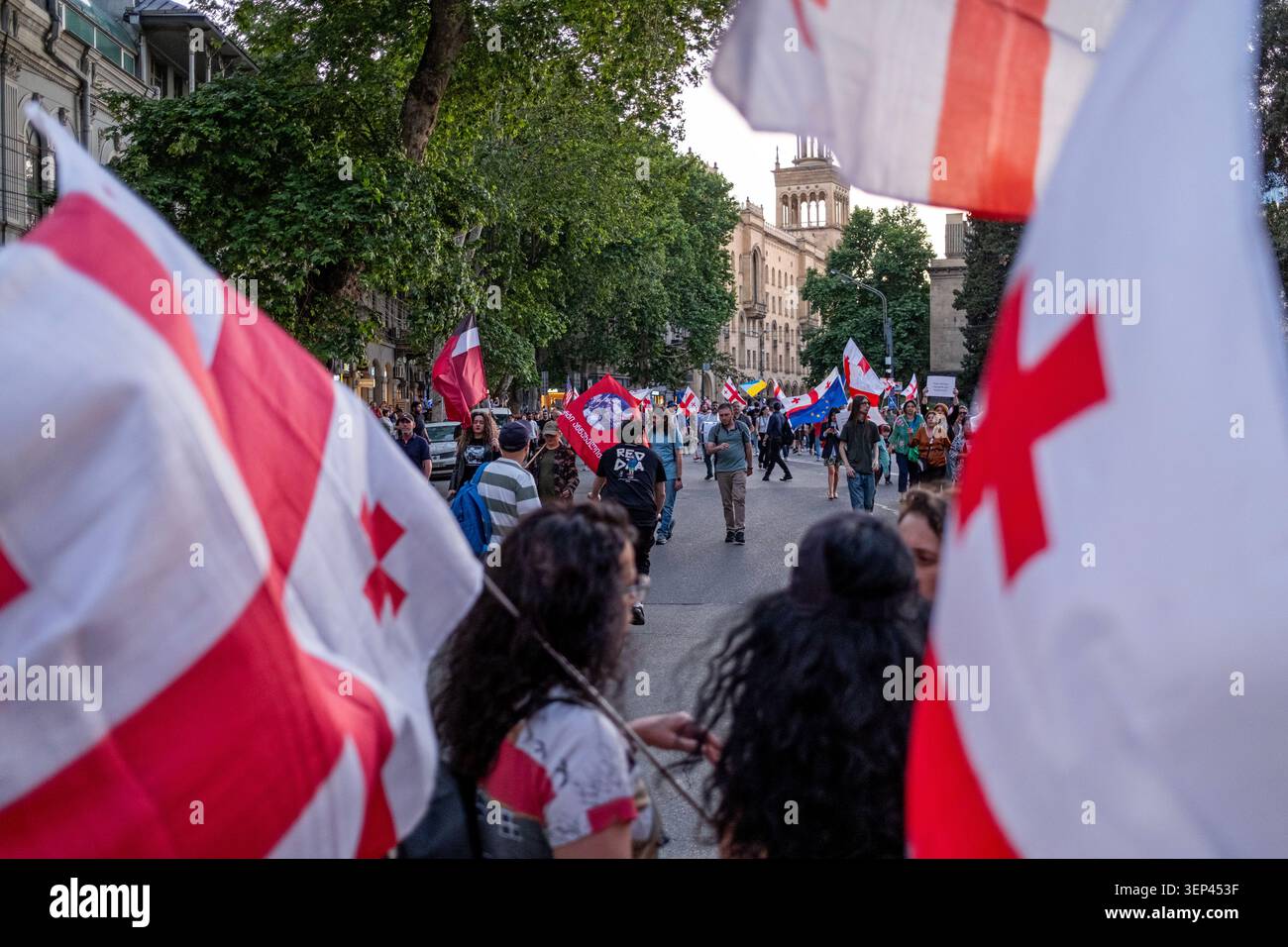 Tbilisi, Georgia, June 13, 2026. Protesters hold Georgian flags as they ...