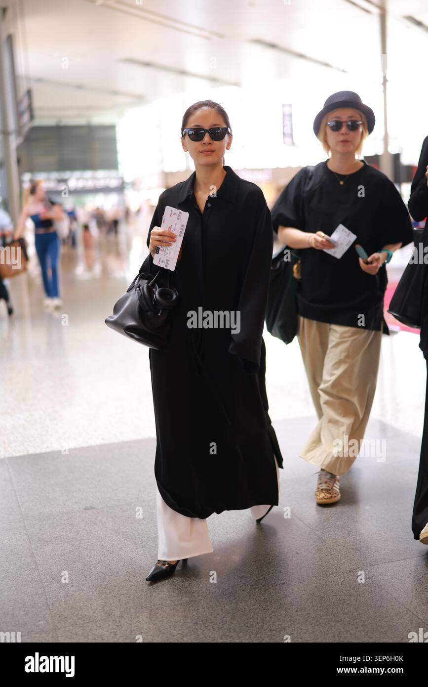 Chinese actress Wang Ziwen arrives at the airport in a black dress in ...