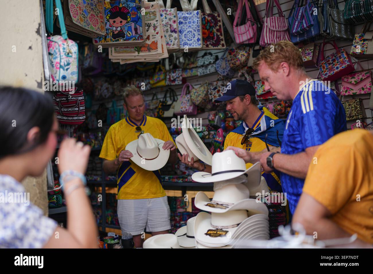 Swedish soccer fans shop for cowboy hats in the historic district of ...
