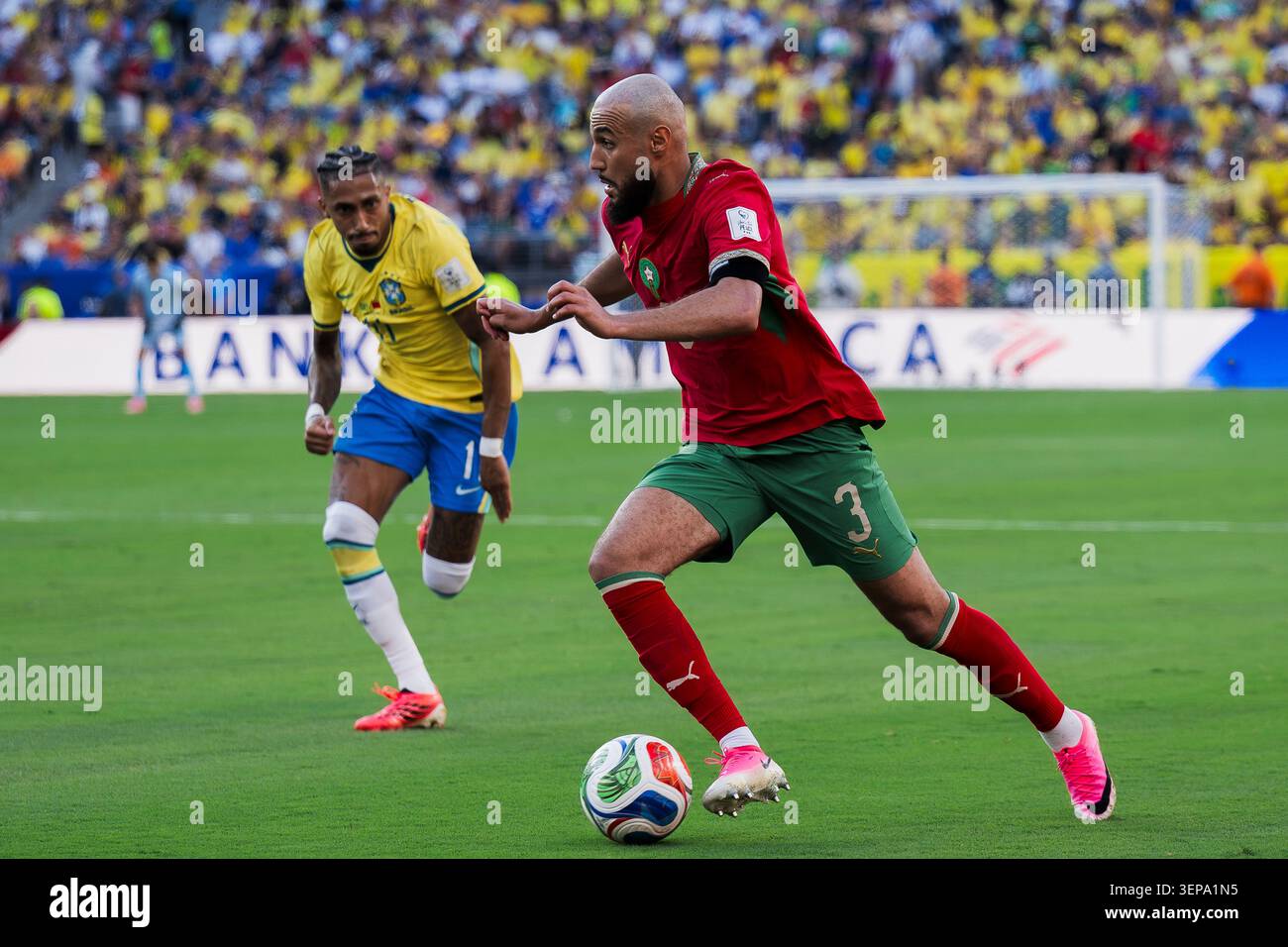 Noussair Mazraoui of Morocco is challenged by Raphinha of Brazil during ...
