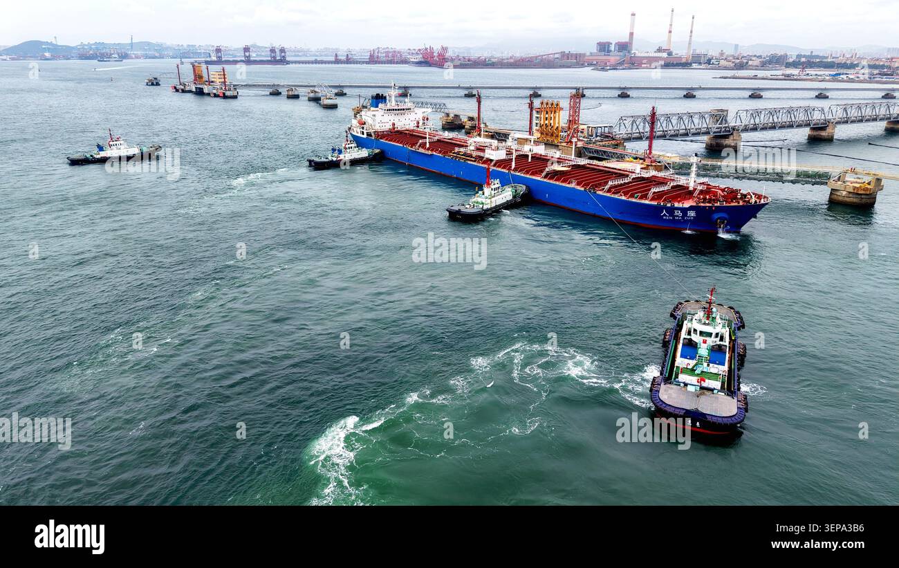 An oil tanker carrying imported crude oil docks at a berth in Qingdao ...