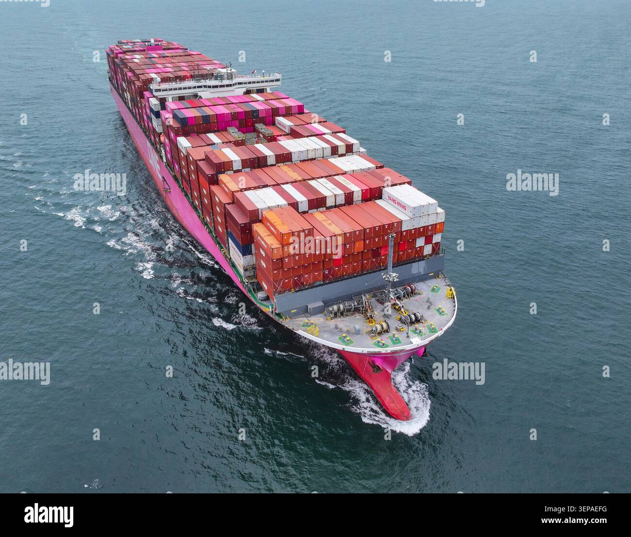 A large ONE container ship and an HMM cargo ship navigate Qingdao Port ...