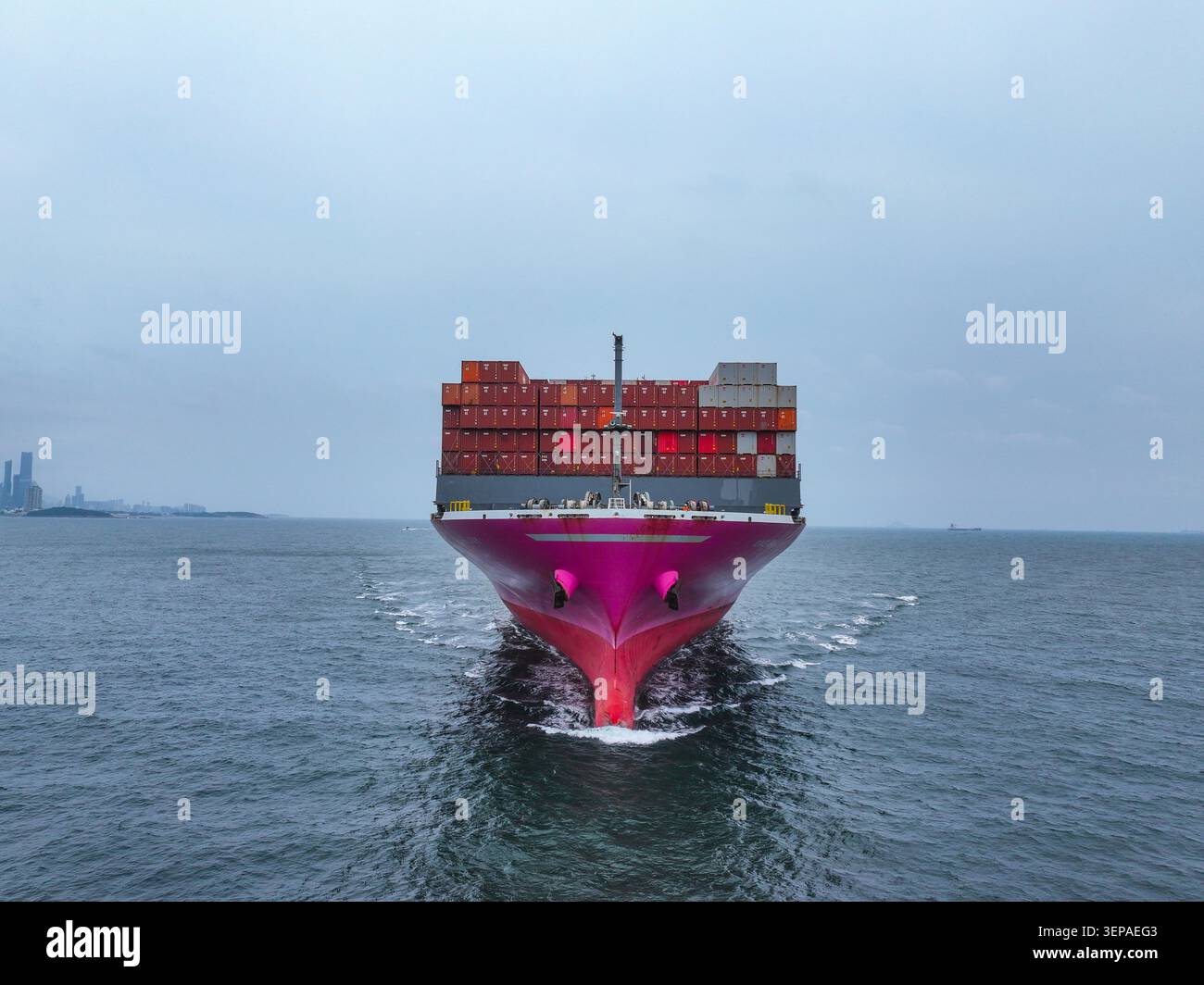 A large ONE container ship and an HMM cargo ship navigate Qingdao Port ...