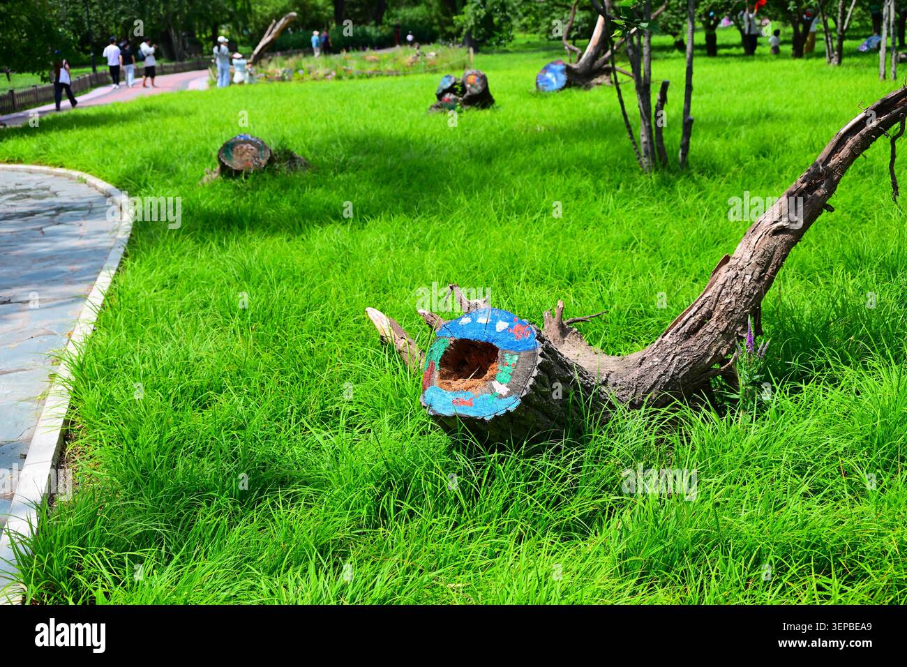 Vibrant cartoon paintings adorn withered tree trunks at Lotus Pond Park ...