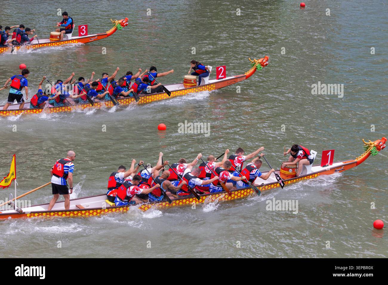 Competitors race during the 2026 Suzhou River Dragon Boat Invitational ...