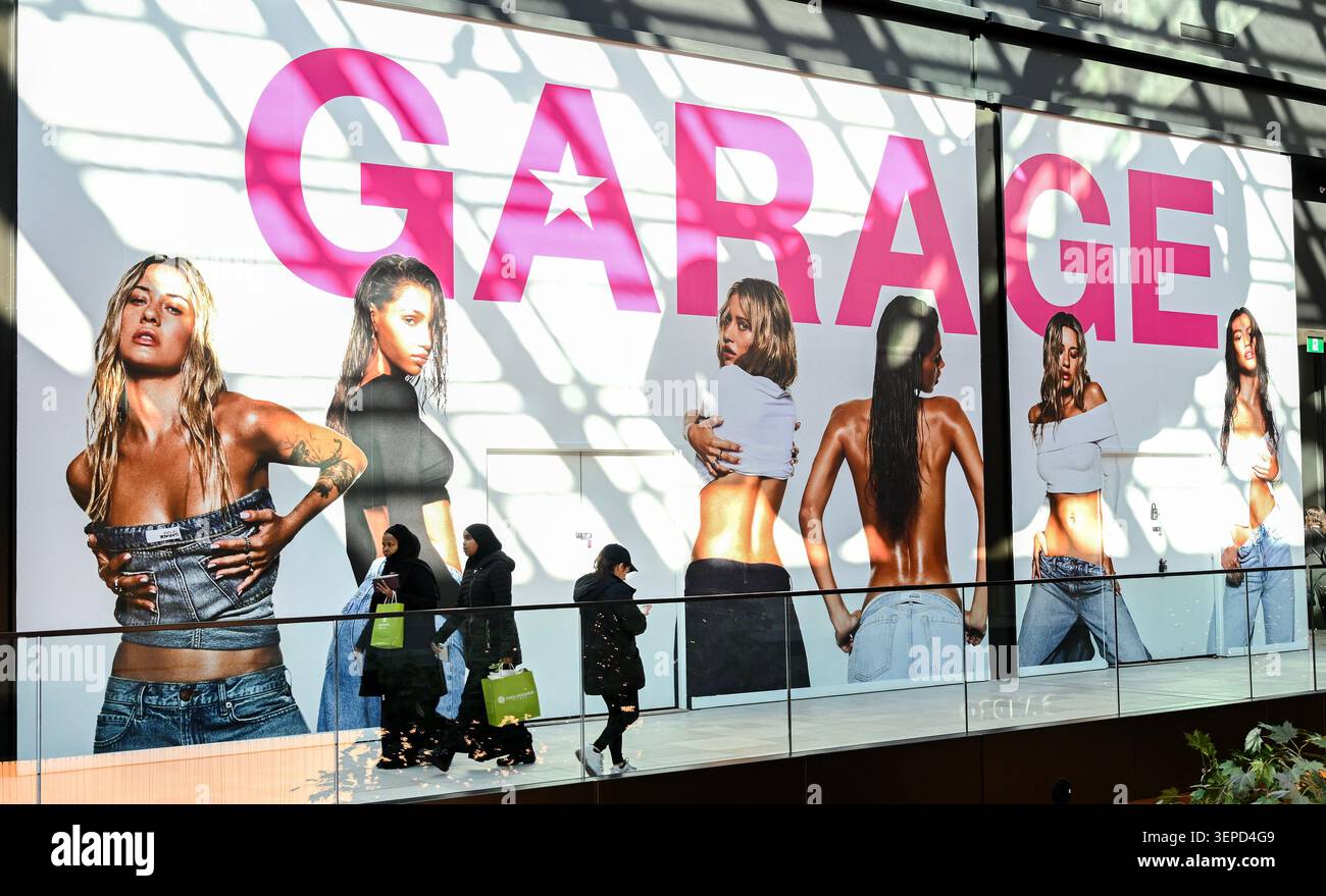 People walk by a Garage clothing retail store in Montreal, Friday, Nov ...