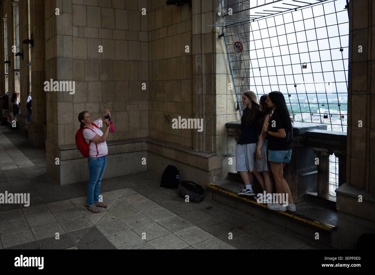 Visitors have their picture taken on the observation deck of the Palace ...