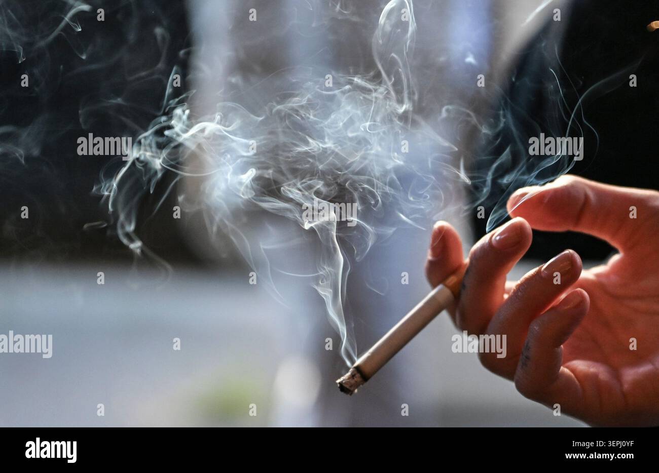 11 June 2026, Berlin: A woman is holding a smoking cigarette. Photo ...