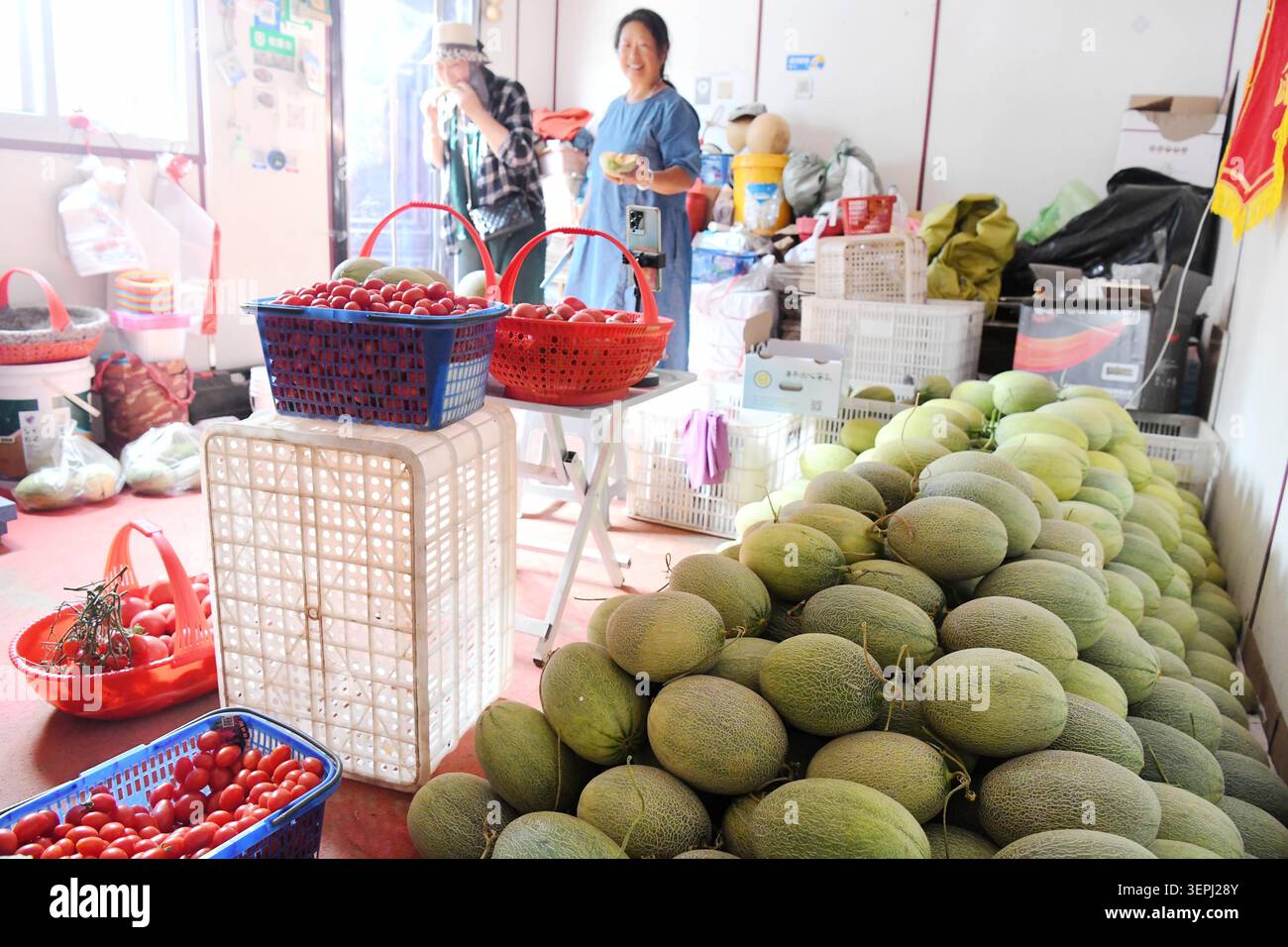 A farmer sells fruits via livestreaming at a vegetable and fruit ...