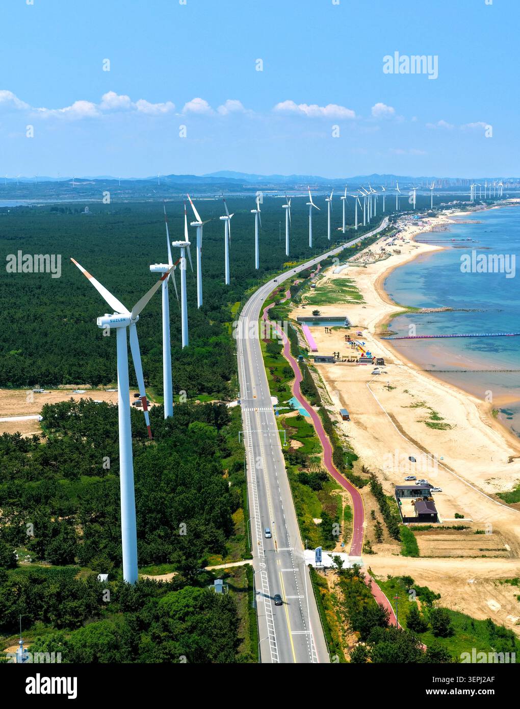 Wind turbines operate in the northern coastal area of Rongcheng, east ...