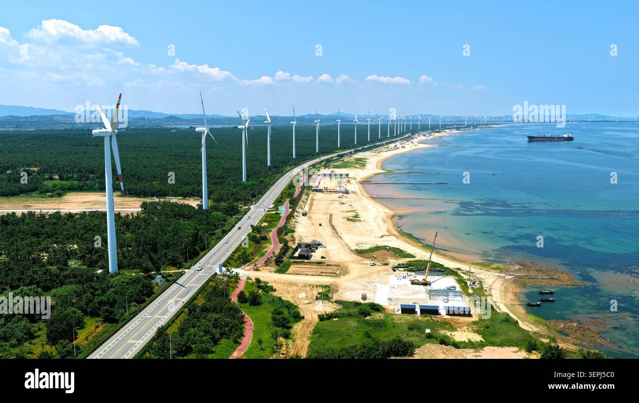 Wind turbines operate in the northern coastal area of Rongcheng, east ...