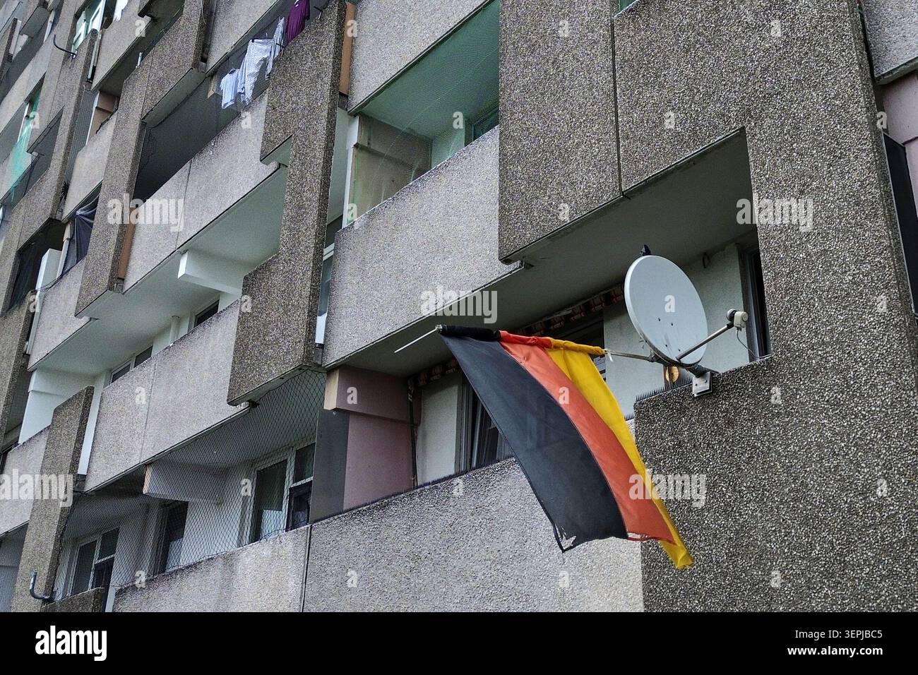 A German flag decorates the balcony of an apartment building in ...