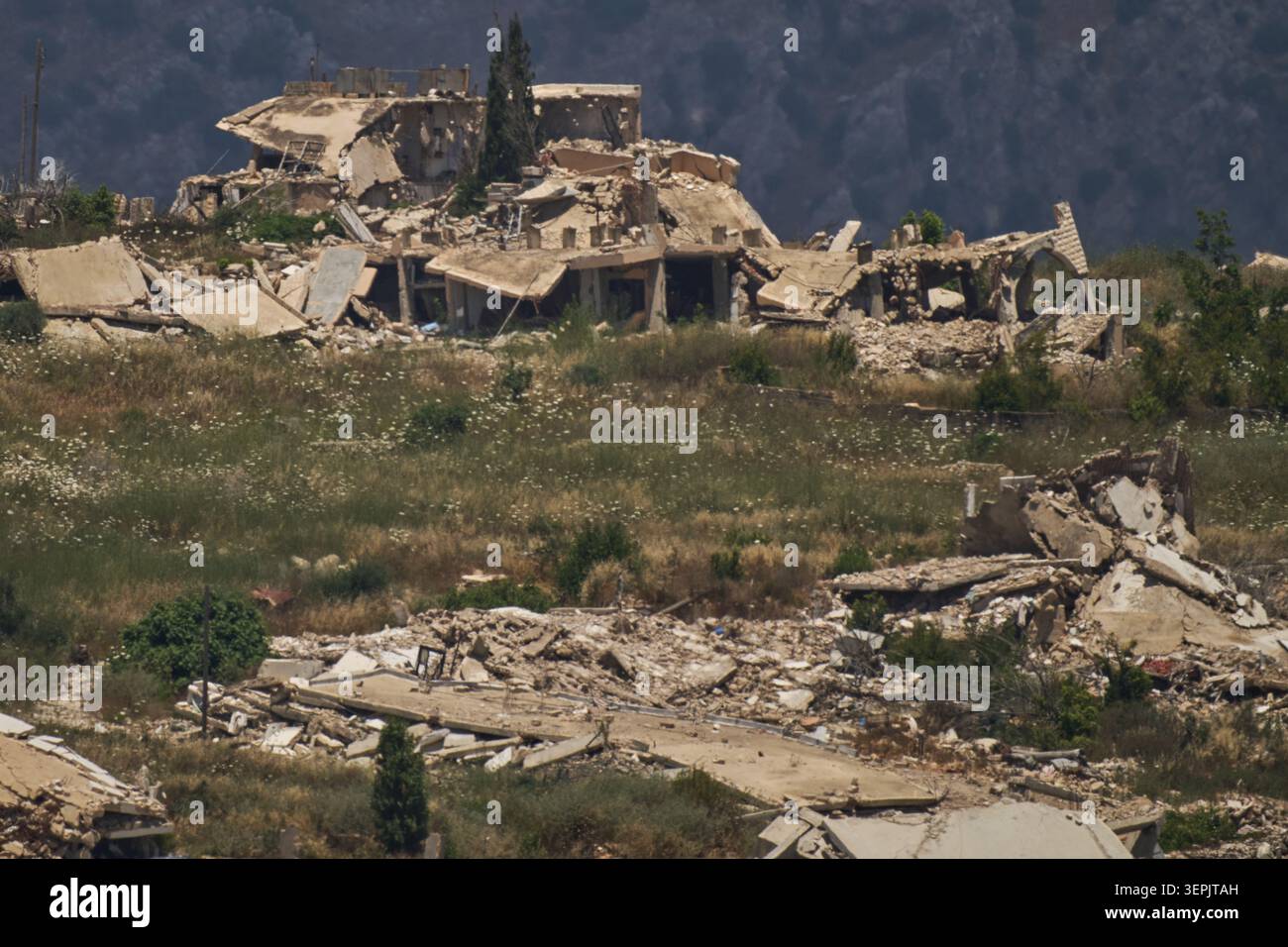 Destroyed buildings stand in a village in southern Lebanon as seen from ...