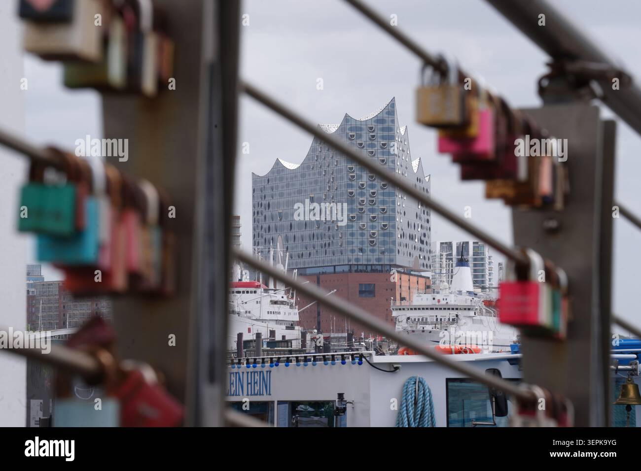 15 June 2026, Hamburg: The Elbphilharmonie can be seen through a fence ...