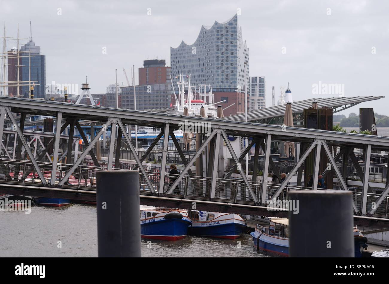 15 June 2026, Hamburg: Pedestrians are walking across a bridge at the ...