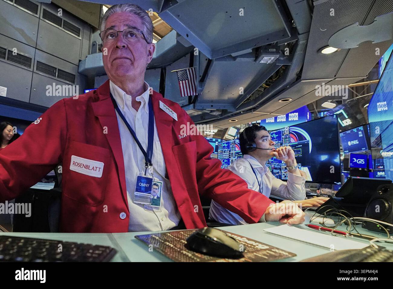 Trader Daniel Kryger, left, works on the floor of the New York Stock ...