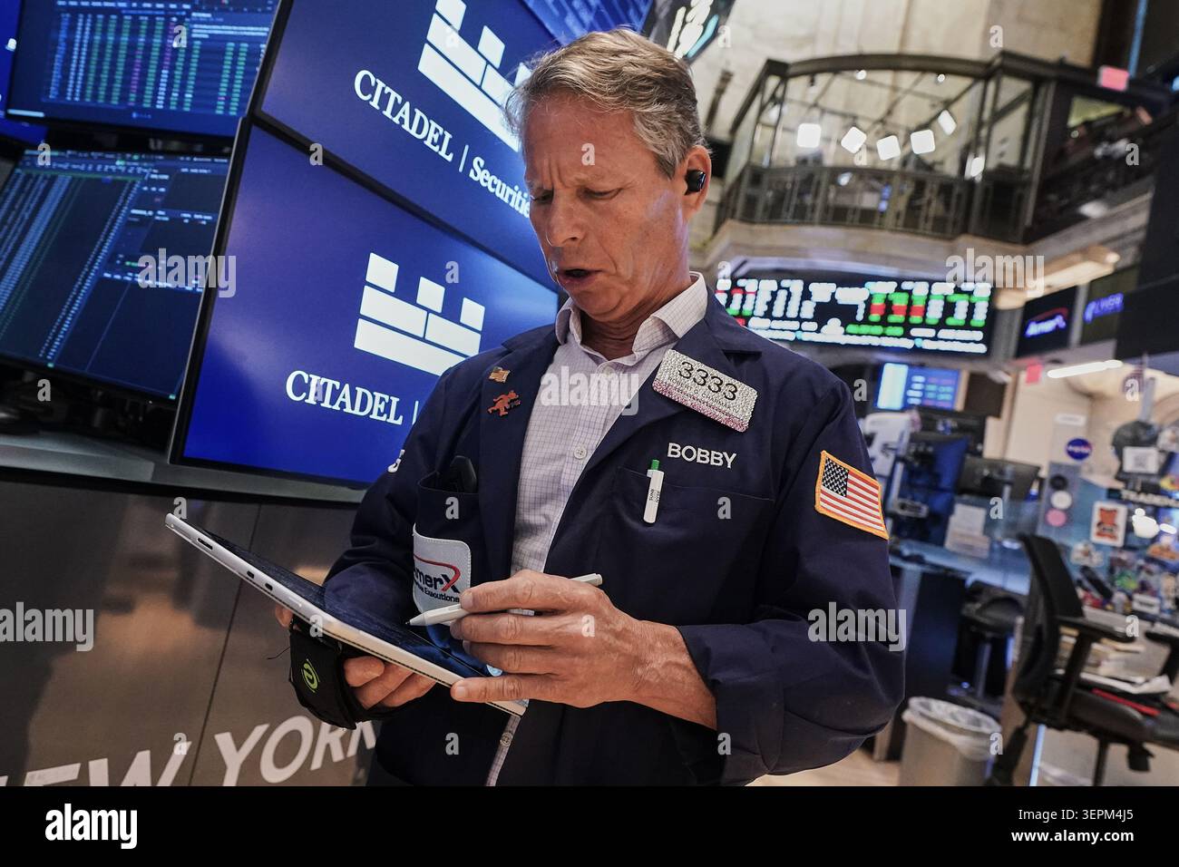 Trader Robert Charmak works on the floor of the New York Stock Exchange ...