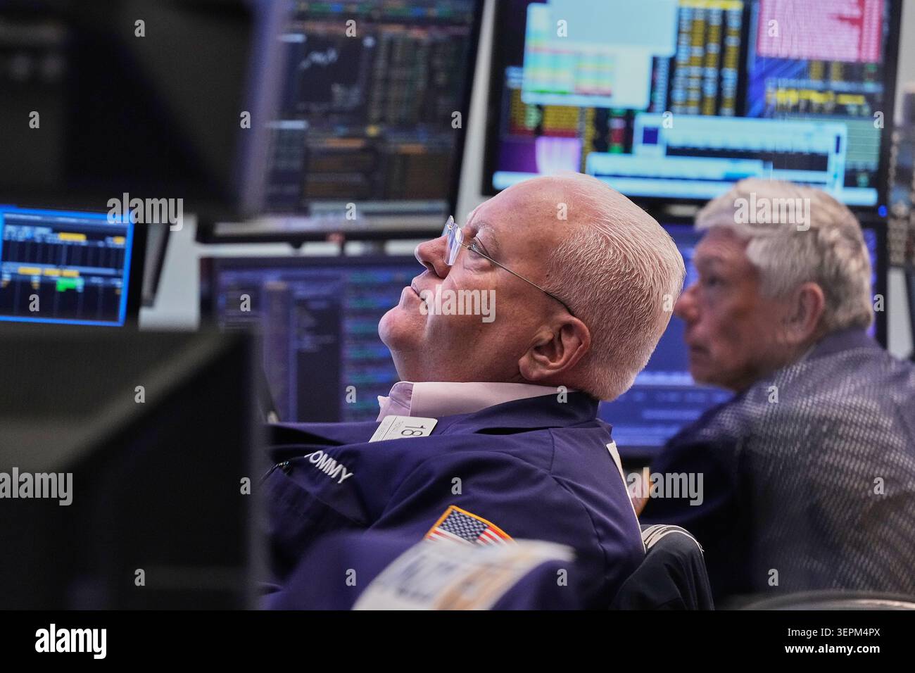 Trader Thomas Ferrigno, left, works on the floor of the New York Stock ...