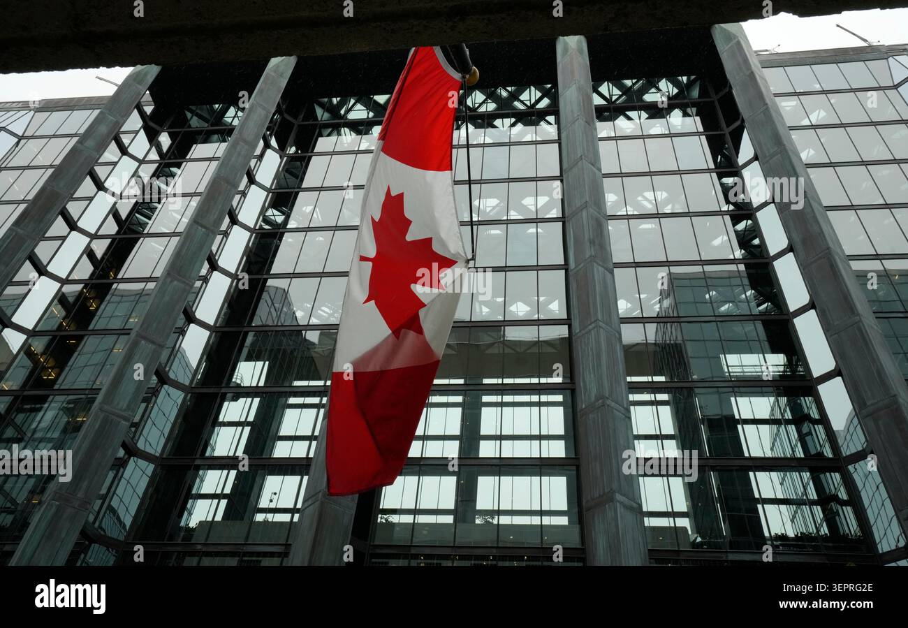 The Canadian flag hangs from a building outside the Bank of Canada in ...