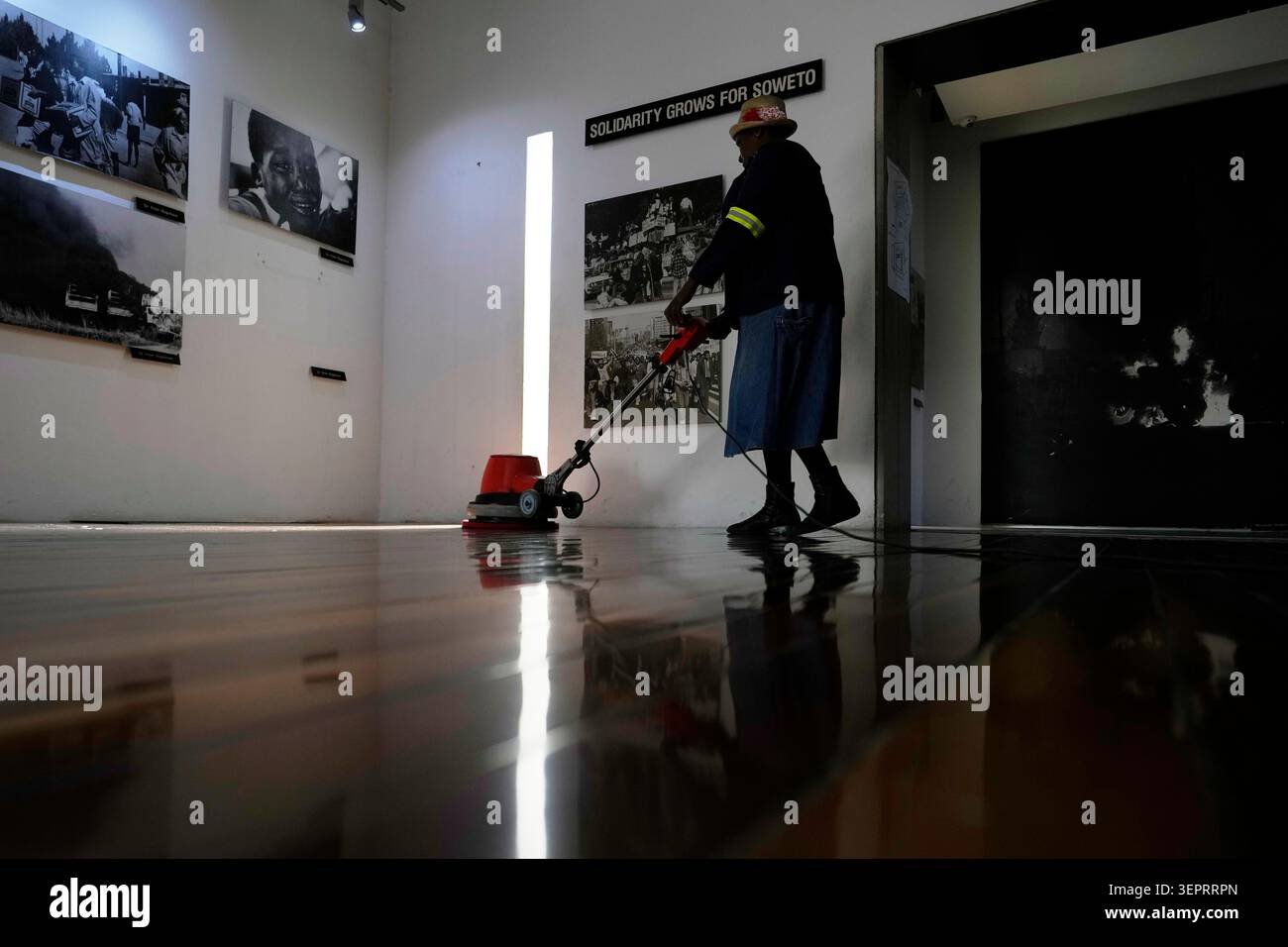 A worker polishes the floor at The Hector Pieterson Memorial and Museum ...
