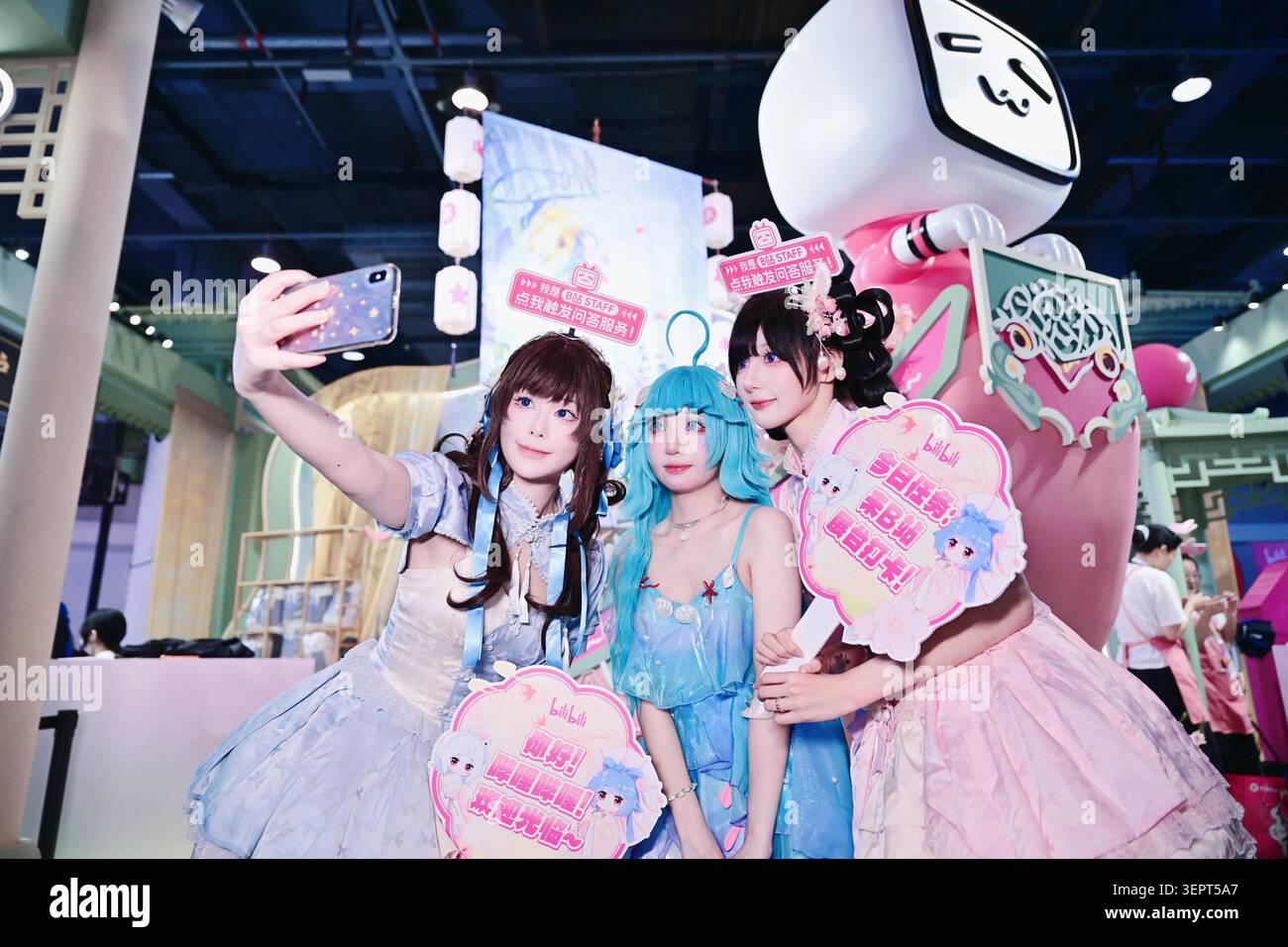 Visitors take selfies with staff at Bilibili's booth during the 22nd ...