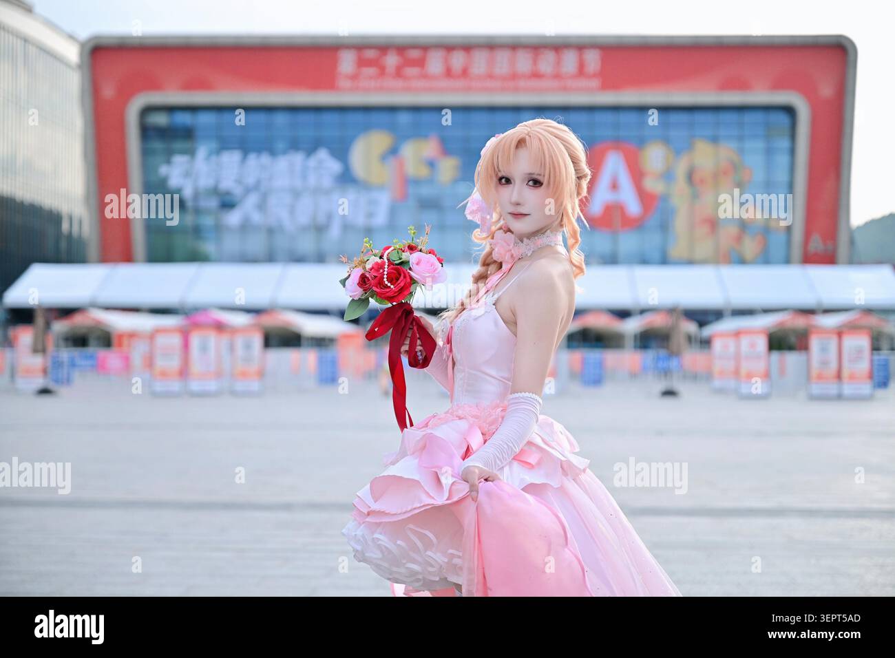 Visitors pose with cosplayers at the entrance of the 22nd China ...